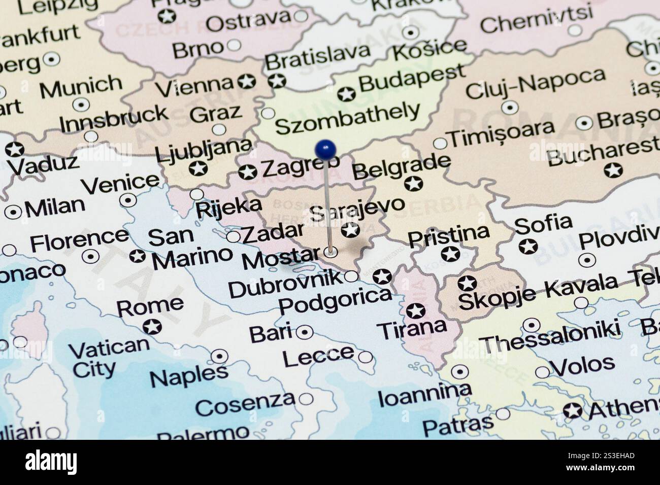 Macro photo of a blue pin needle into Mostar city of Bosnia and ...