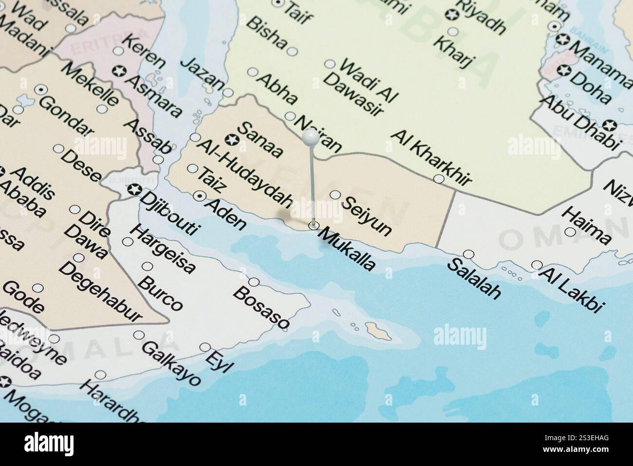 Macro photo of a white pin needle into Mukalla city of Yemen political ...