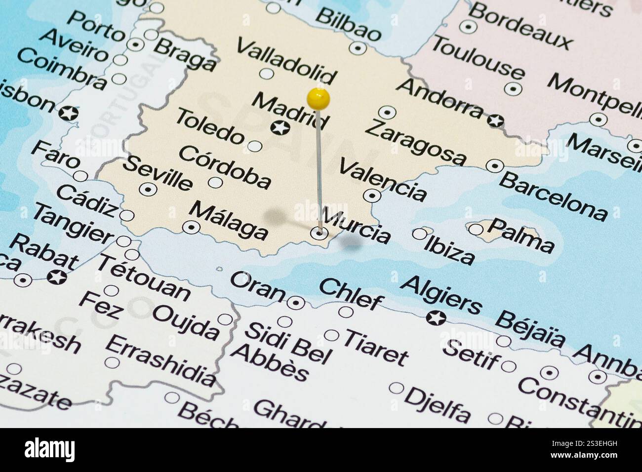 Macro photo of a yellow pin needle into Murcia city of Spain political ...