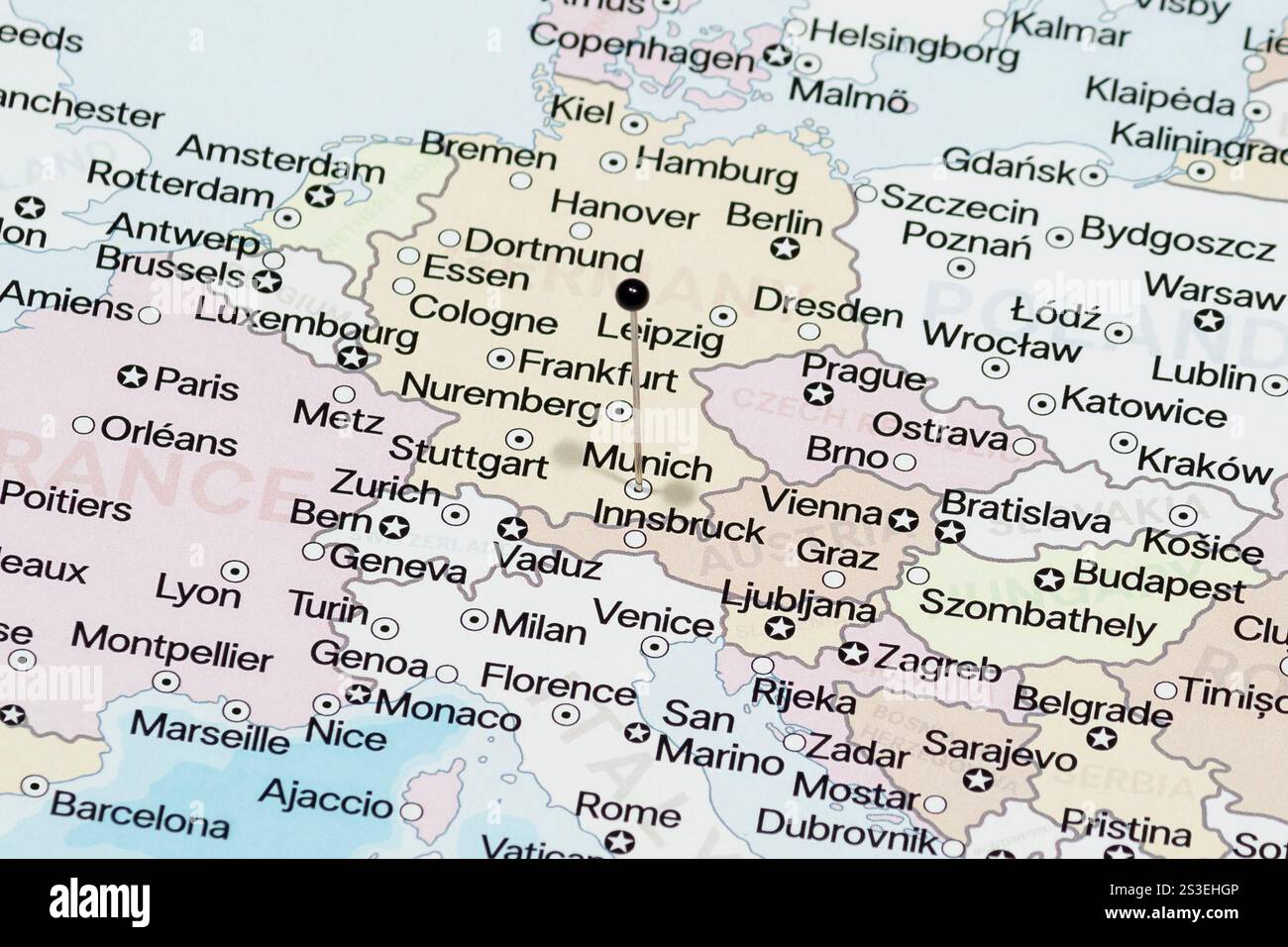 Macro photo of a black pin needle into Munich city of Germany political ...