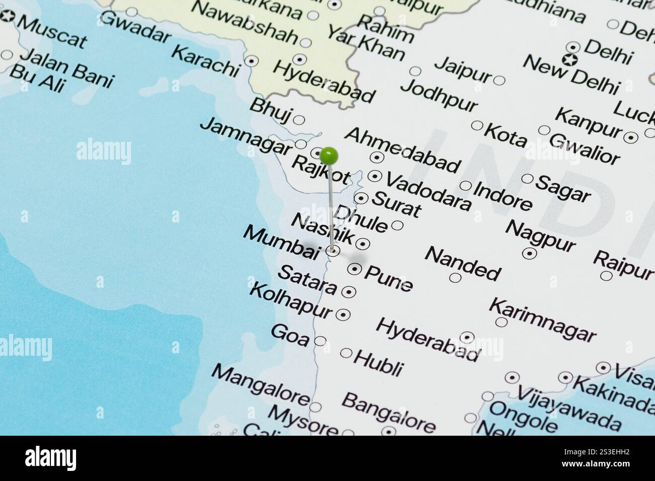 Macro photo of a green pin needle into Mumbai city of India political ...