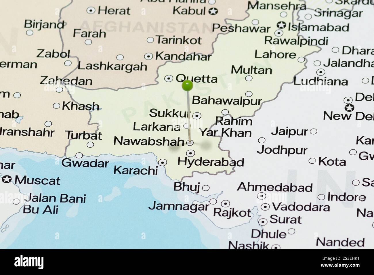 Macro photo of a green pin needle into Nawabshah city of Pakistan ...