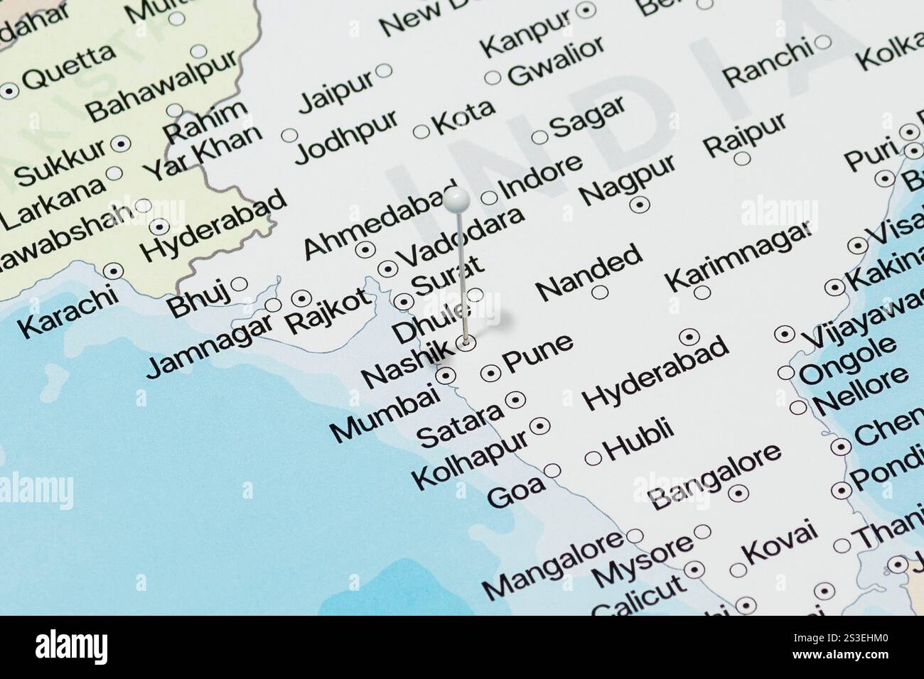 Macro photo of a white pin needle into Nashik city of India political ...