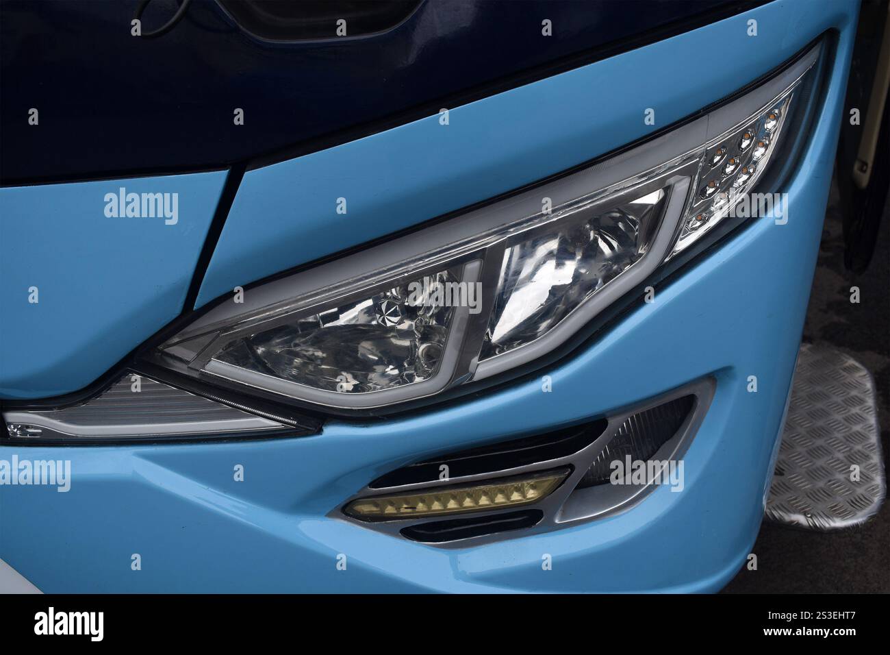 Headlamp design of a blue tour bus Stock Photo - Alamy