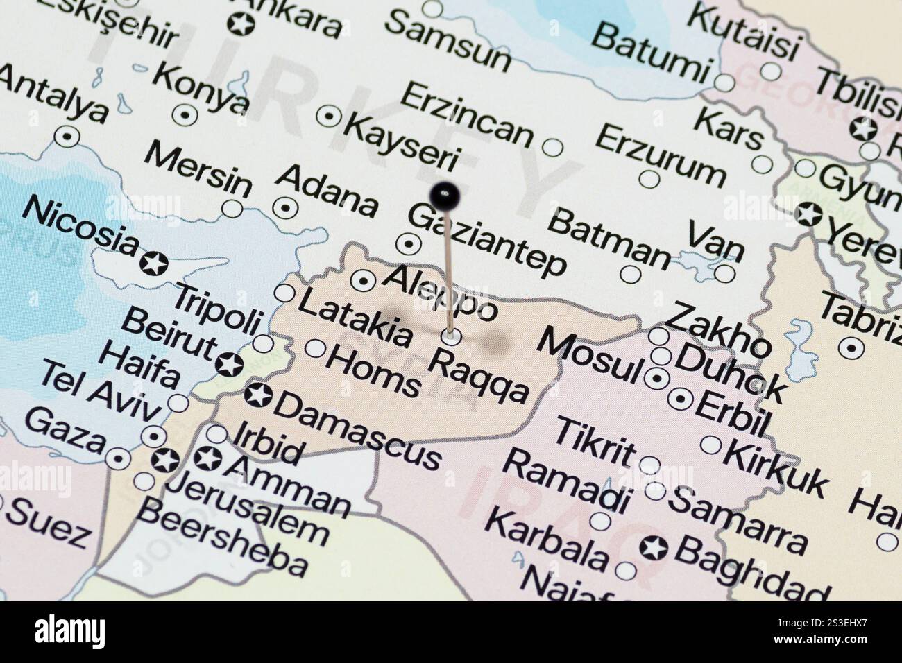 Macro photo of a white pin needle into Raqqa city of Syria political ...