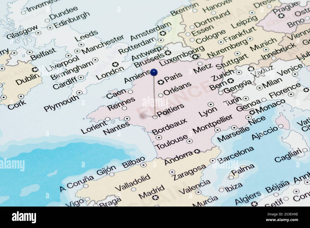 Macro photo of a blue pin needle into Poitiers city of France political ...