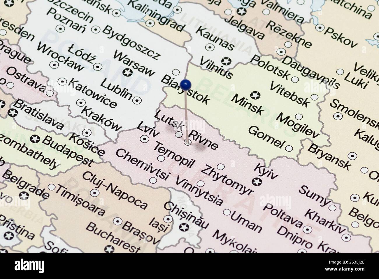 Macro photo of a blue pin needle into Rivne city of Ukraine political ...