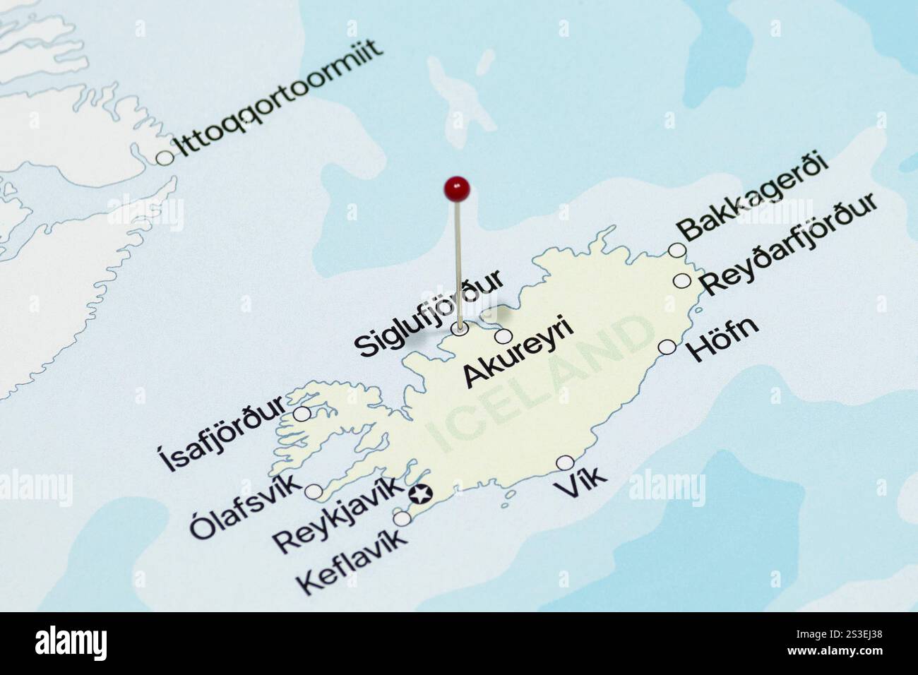 Macro photo of a red pin needle into Siglufjordur city of Iceland ...