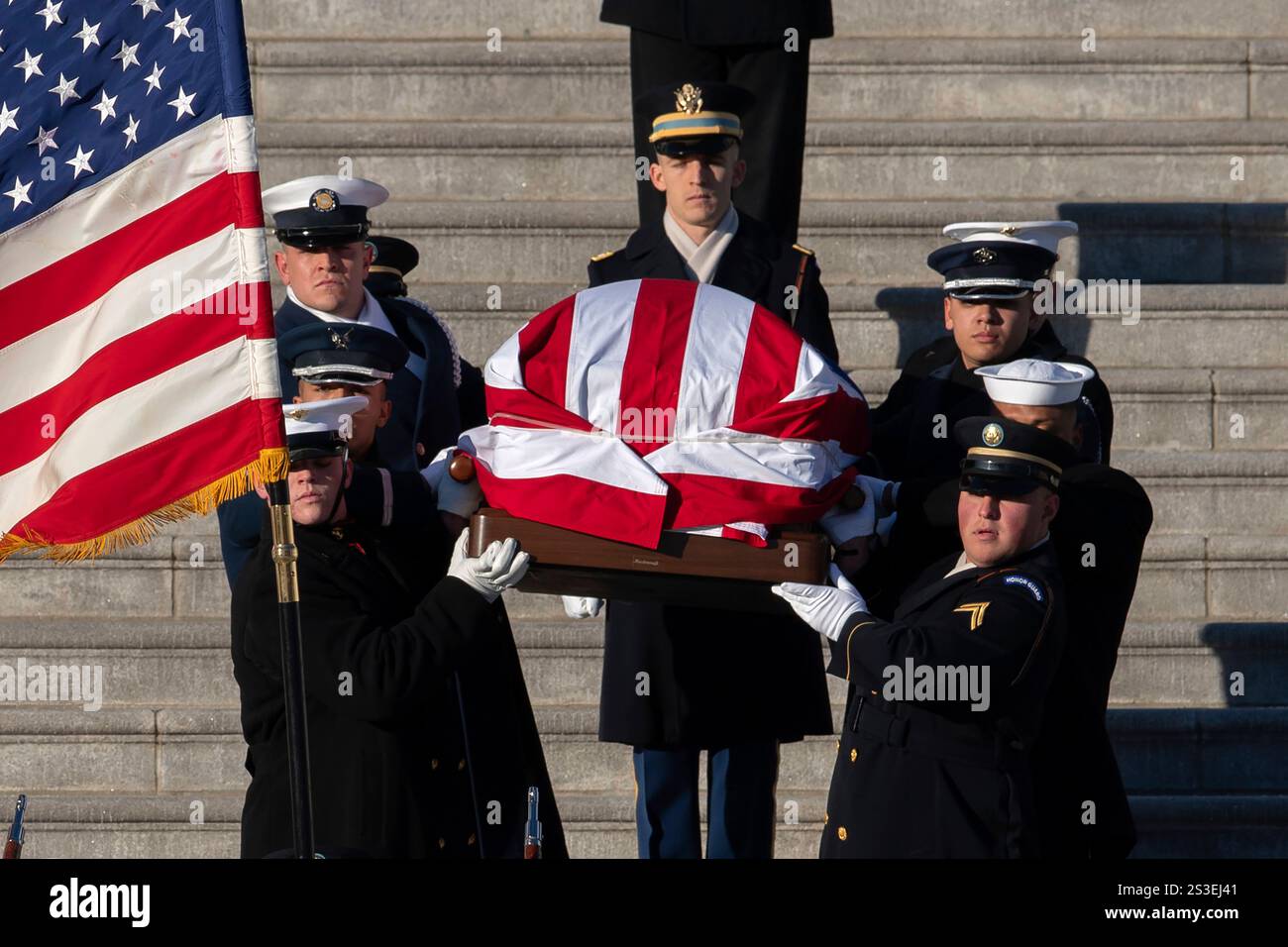 The flag-draped casket of former President Jimmy Carter is carried from ...