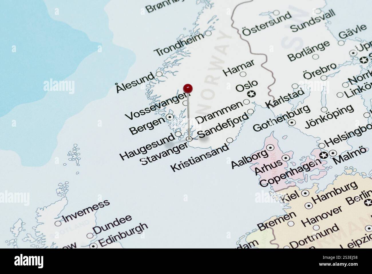 Macro photo of a red pin needle into Stavanger city of Norway political ...