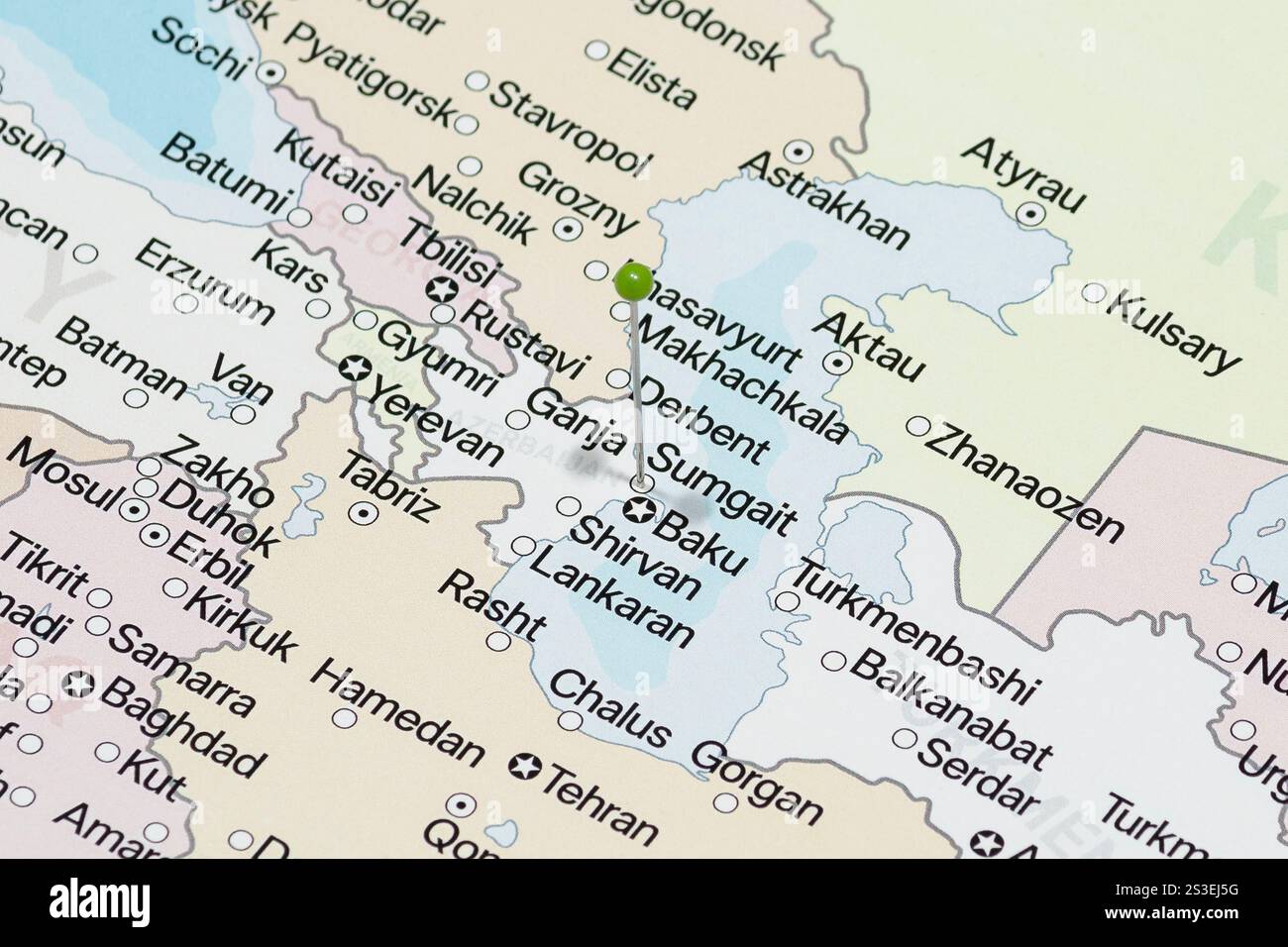 Macro photo of a green pin needle into Sumgait city of Azerbaijan ...