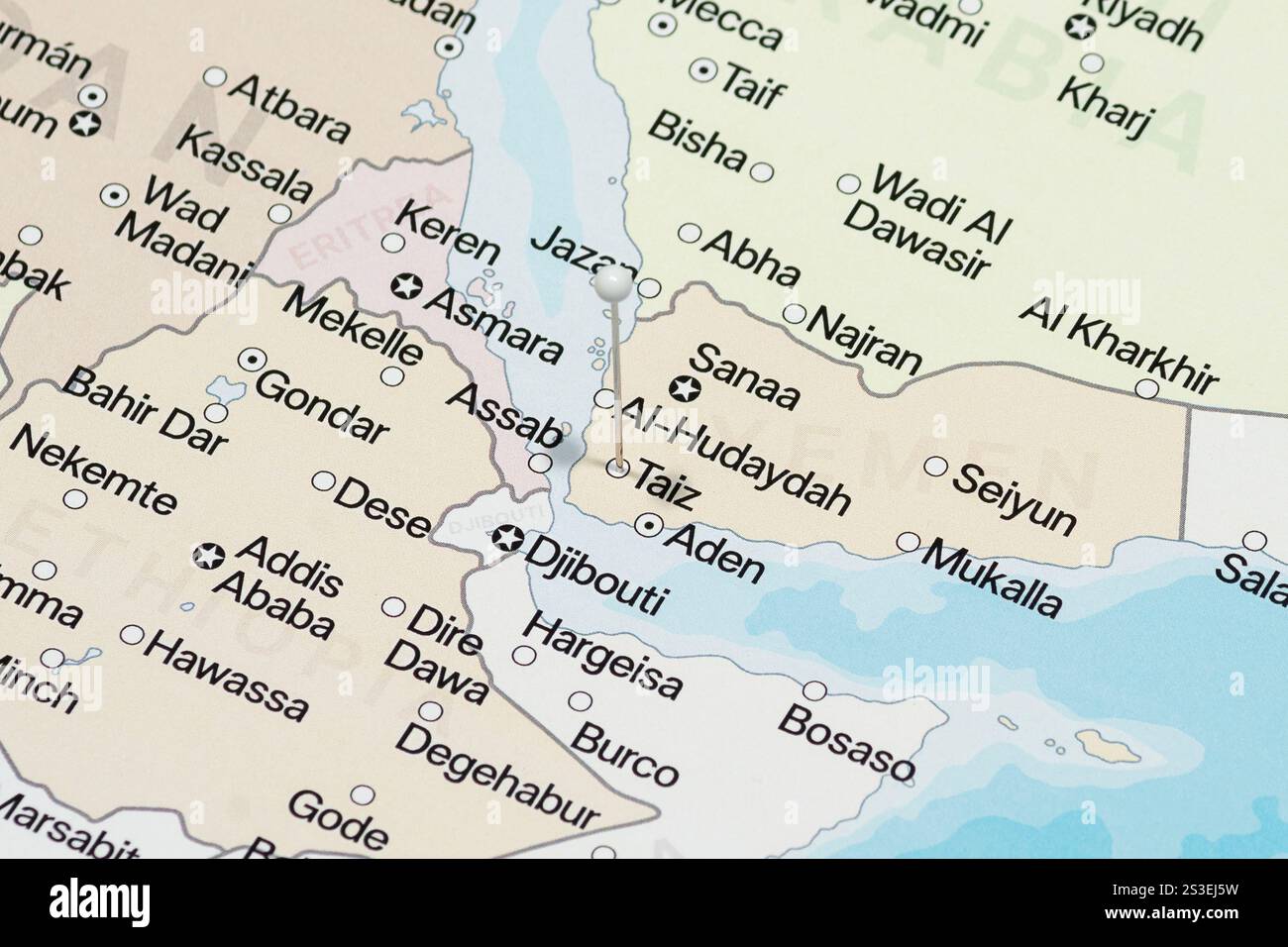 Macro photo of a white pin needle into Taiz city of Yemen political map ...
