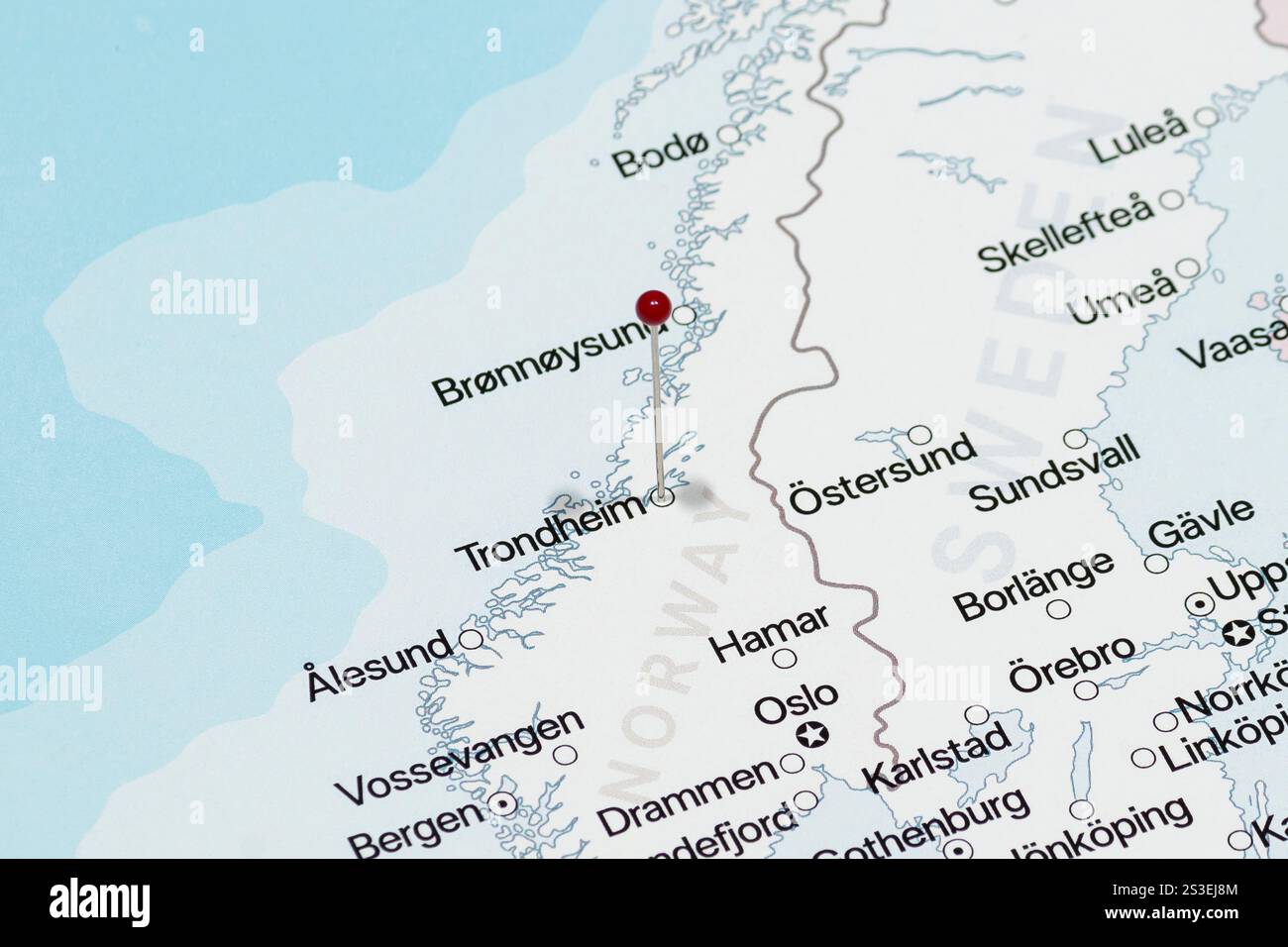 Macro photo of a red pin needle into Trondheim city of Norway political ...