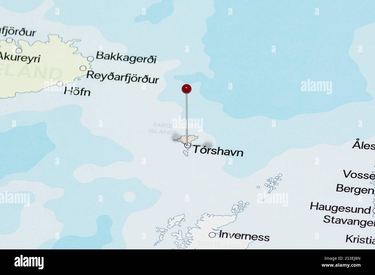 Macro photo of a red pin needle into Torshavn city of Faroe Islands ...