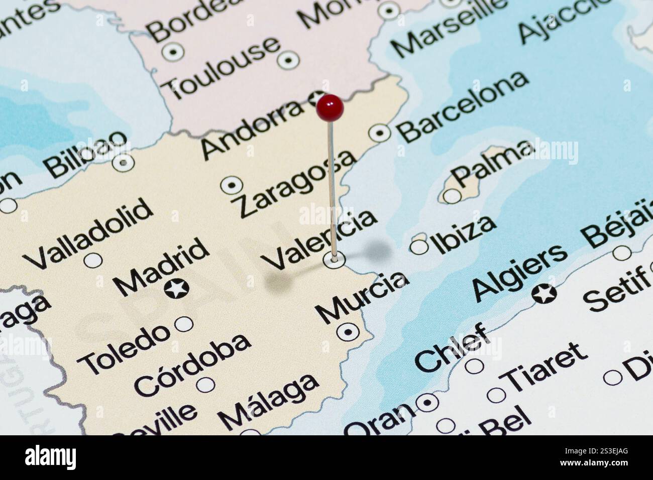 Macro photo of a red pin needle into Valencia city of Spain political ...