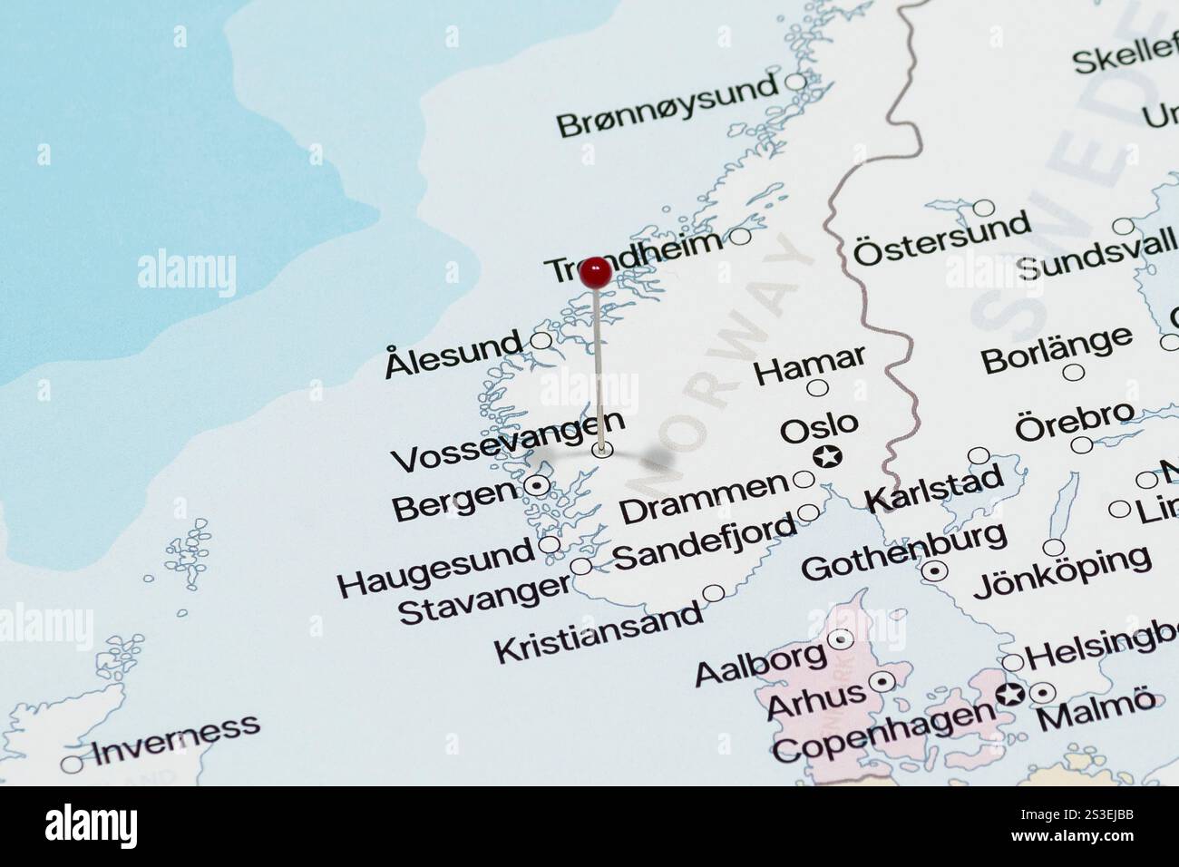 Macro photo of a red pin needle into Vossevangen city of Norway ...