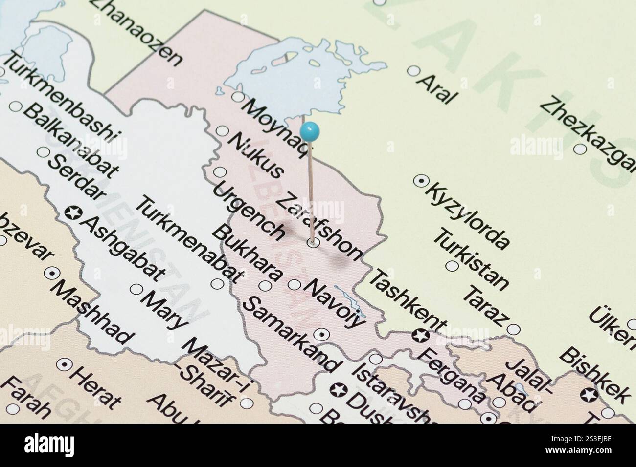 Macro photo of a light blue pin needle into Zarafshon city of ...