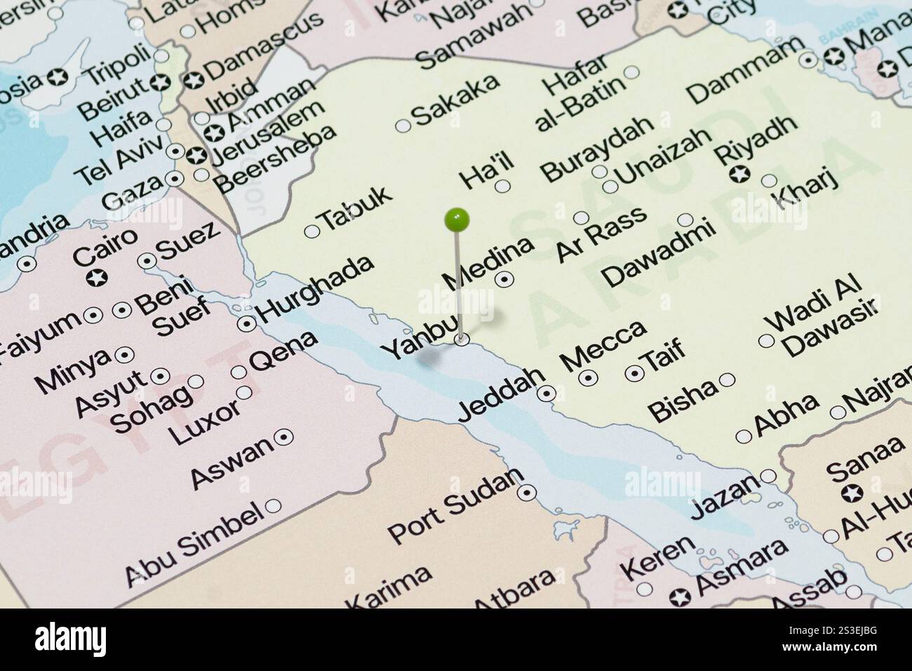 Macro photo of a green pin needle into Yanbu city of Saudi Arabia ...