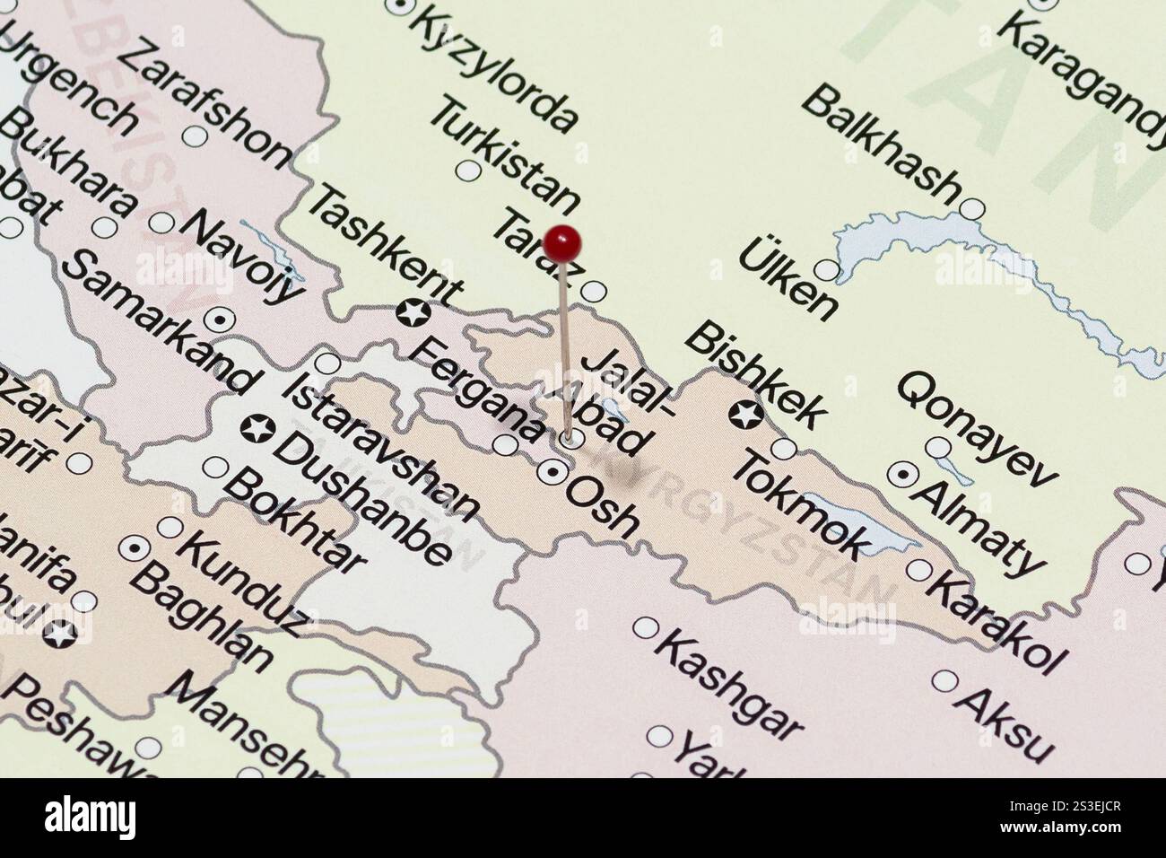 Macro photo of a red pin needle into Jalal Abad city of Kyrgyzstan ...