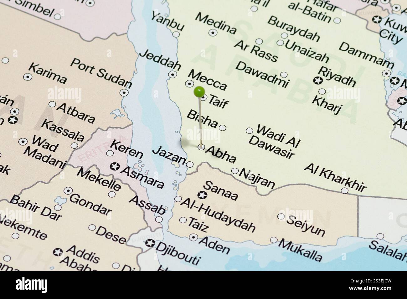 Macro photo of a green pin needle into Abha city of Saudi Arabia ...