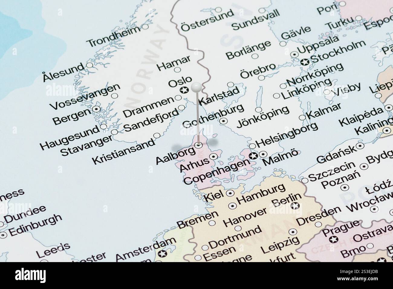 Macro photo of a white pin needle into Aalborg city of Denmark ...