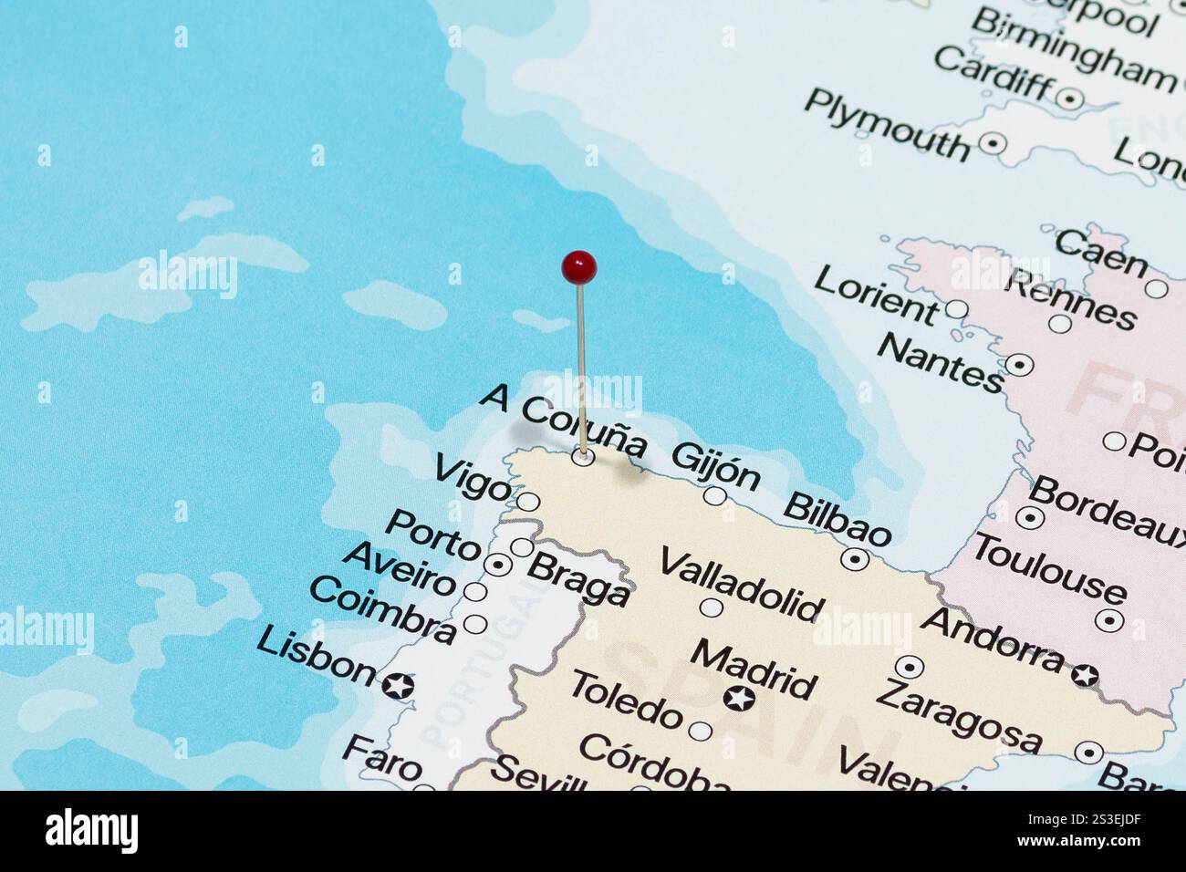 Macro photo of a red pin needle into A Coruna city of Spain political ...