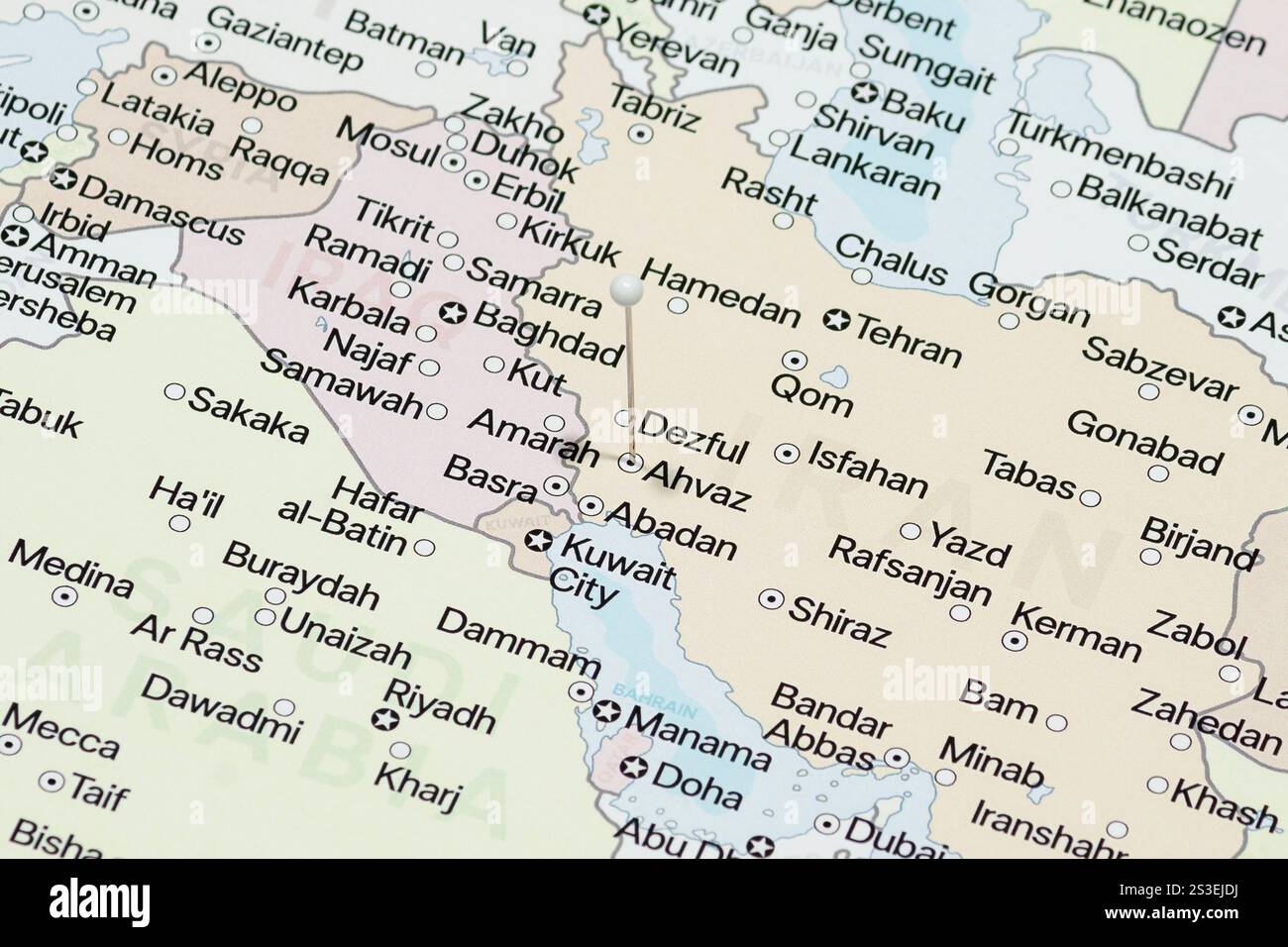 Macro photo of a white pin needle into Ahvaz city of Iran political map ...