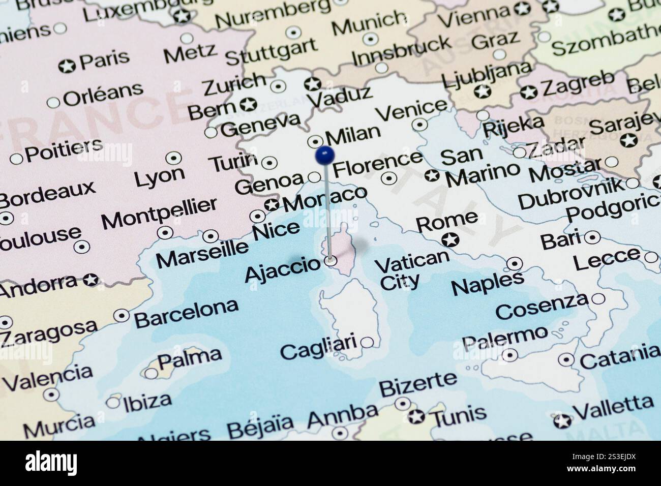 Macro photo of a blue pin needle into Ajaccio city of France political ...