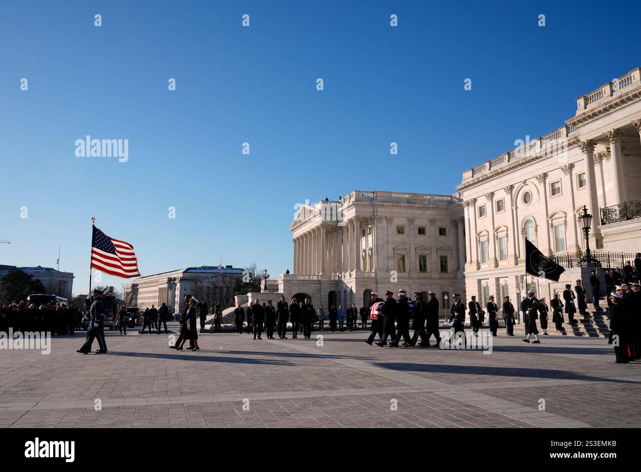 A joint services body bearer team carries the flag-draped casket of ...