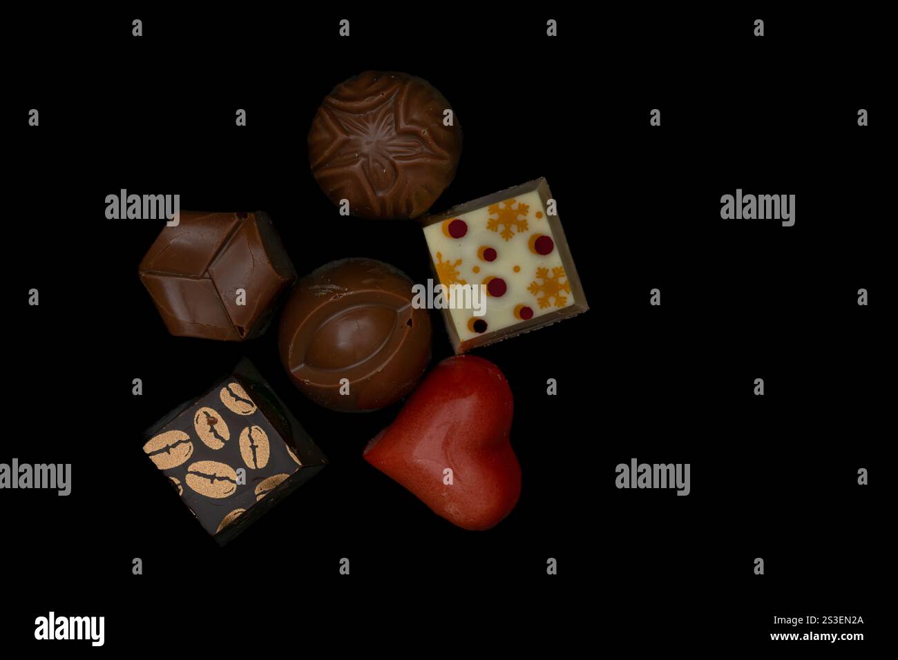Set of five chocolate candy on black dark table Stock Photo - Alamy