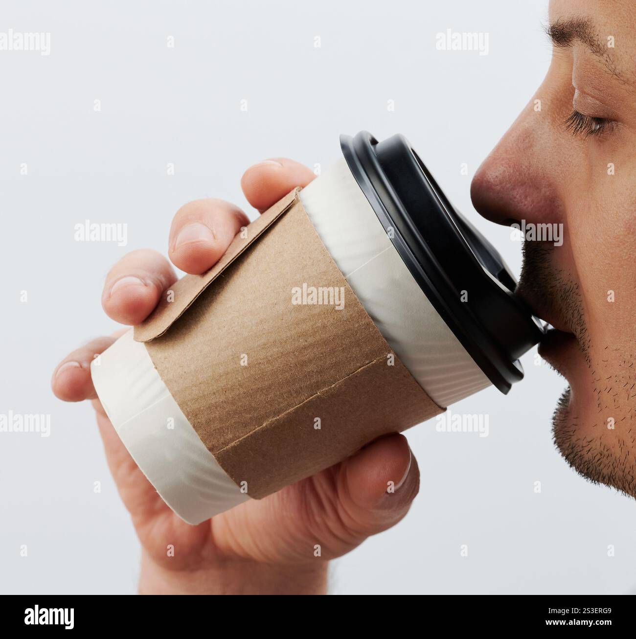 Drinking hot liquid from paper cup profile view isolated on white ...