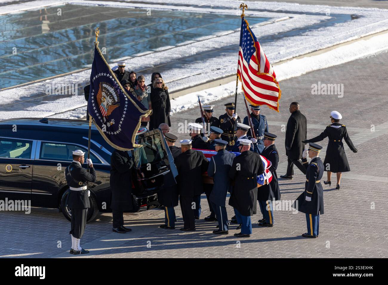 A joint services body bearer team carries the flag-draped casket of ...