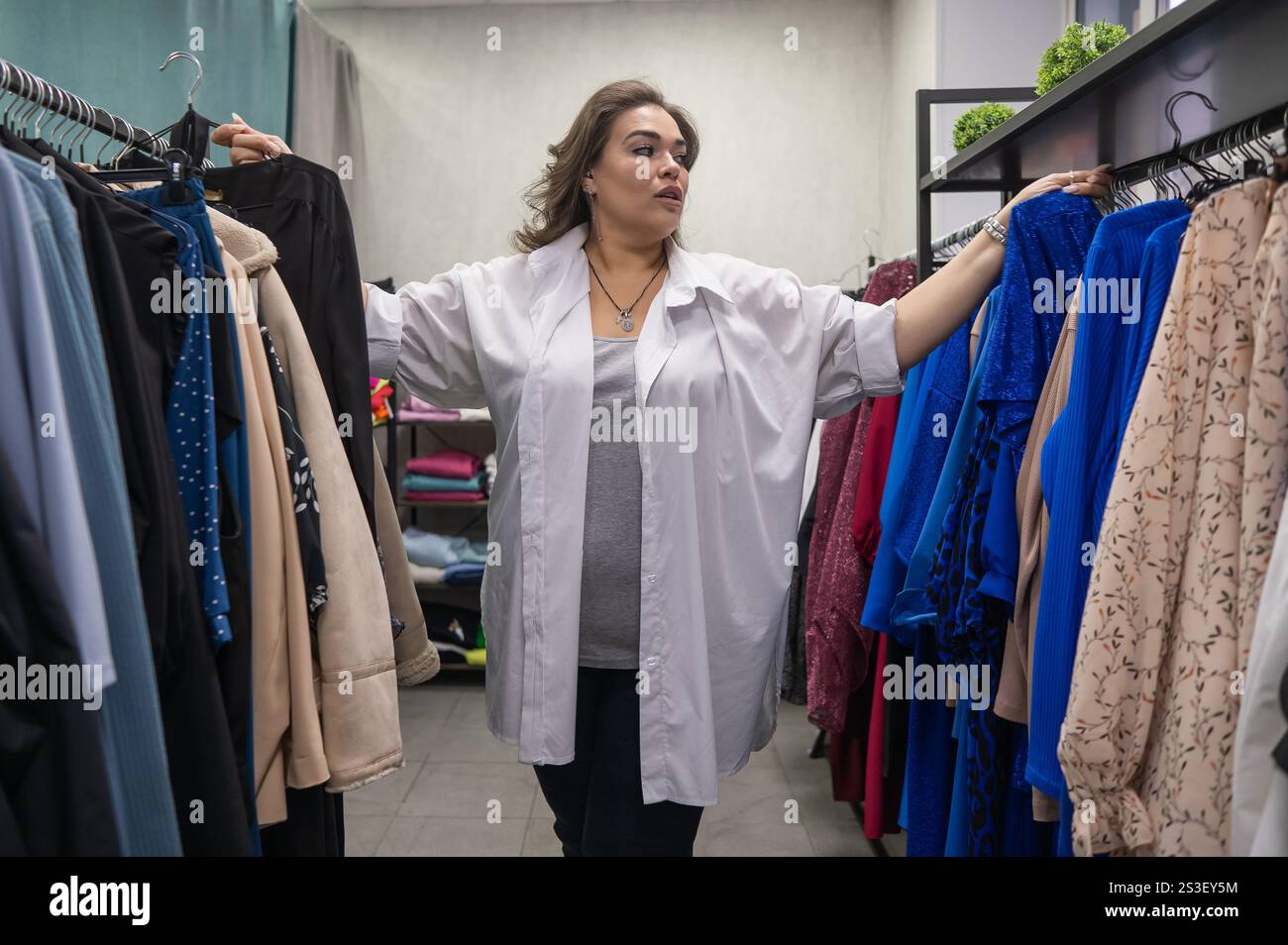 A fat woman chooses clothes in a plus size store Stock Photo - Alamy