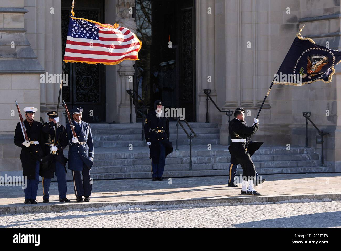 Flag bearers fight the wind during the arrival of the casket of former ...