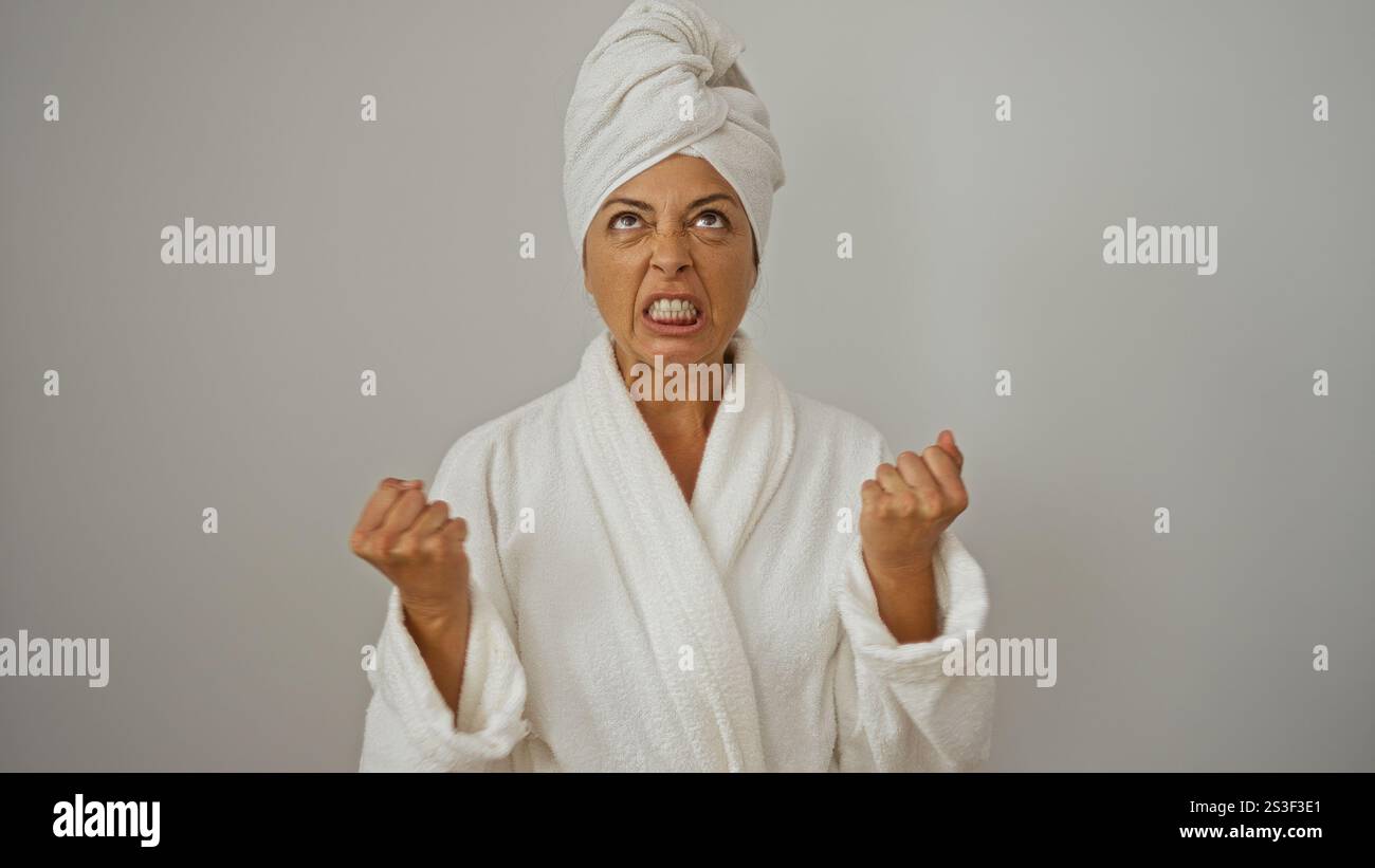Woman angry in white bathrobe and towel showing frustration on isolated ...