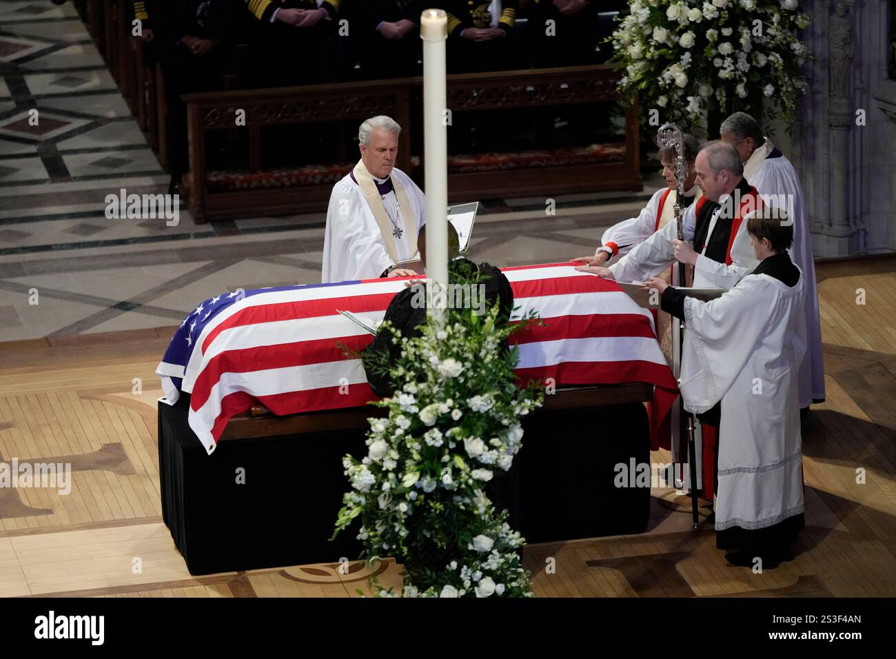 A blessing is given over the flag-draped casket of former President ...