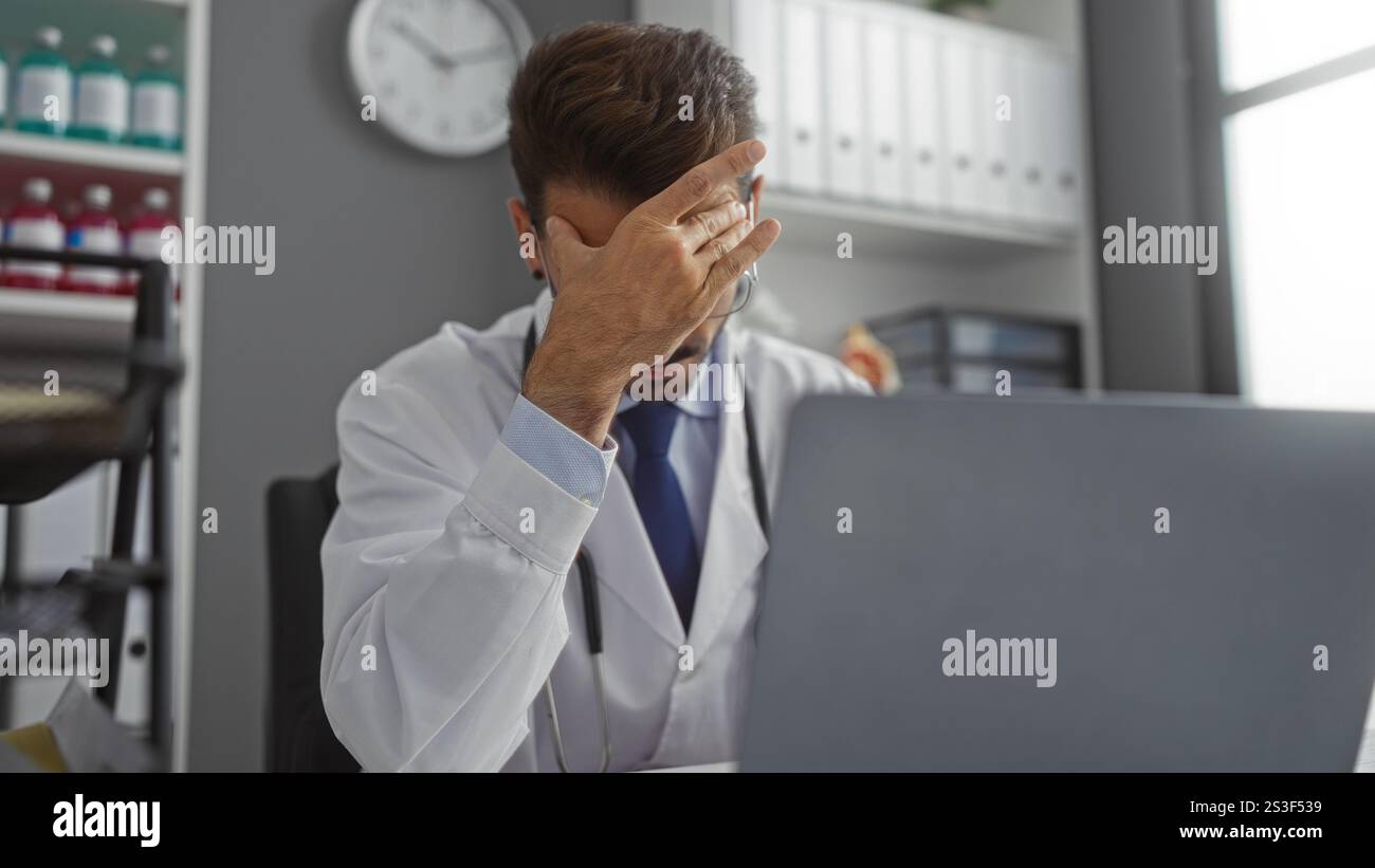 Frustrated doctor man in clinic office wearing white coat stressed at ...