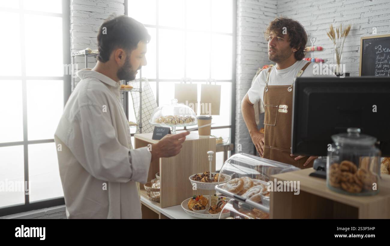 Men discussing at a bakery counter with pastries and coffee in an ...