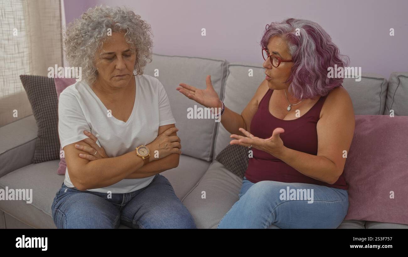 Two mature women having a serious conversation in a cozy living room ...