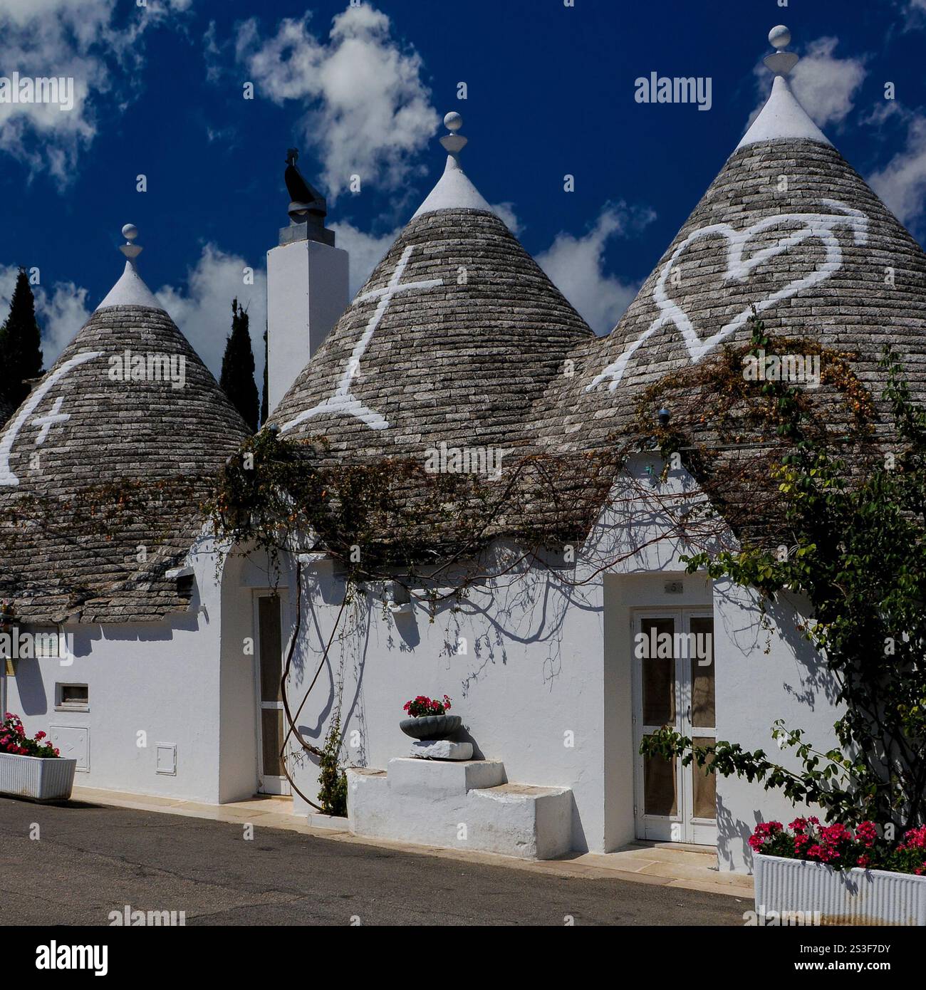 White-painted religious symbols on three pinnacled limestone cones of ...