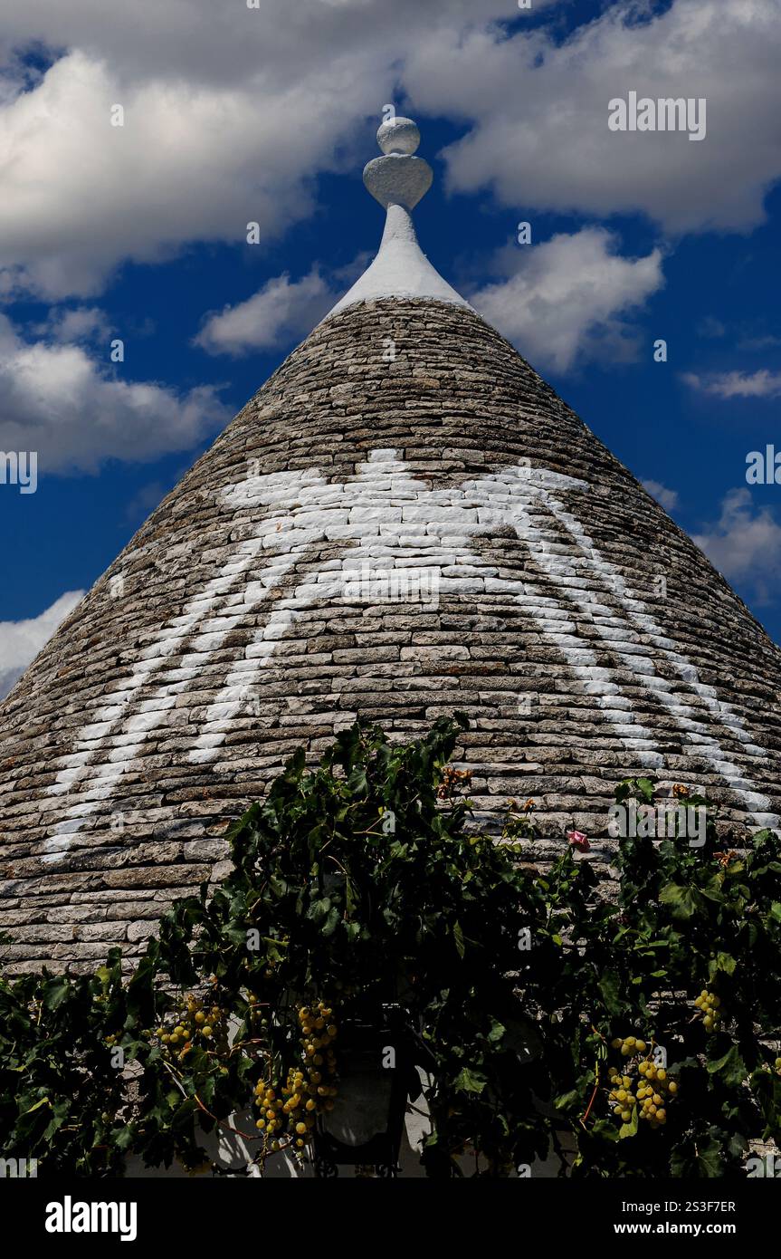 White-painted Christian symbol with rays slanted downward on conical ...
