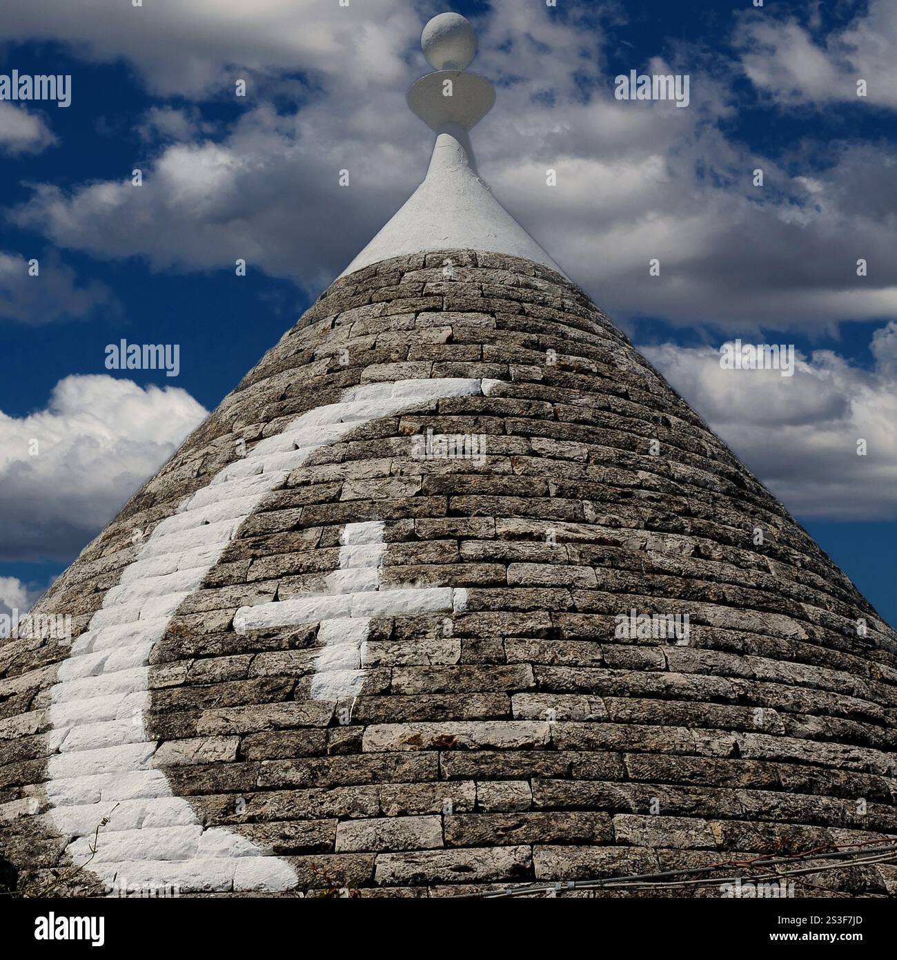 Crescent and cross: white-painted Christian symbol on the conical dry ...