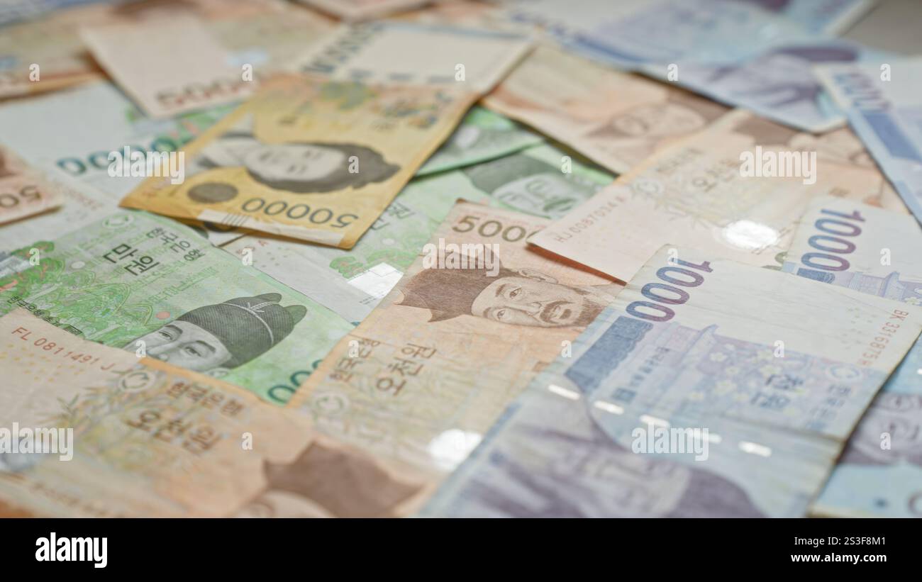 Scattered south korean won banknotes of various denominations ...