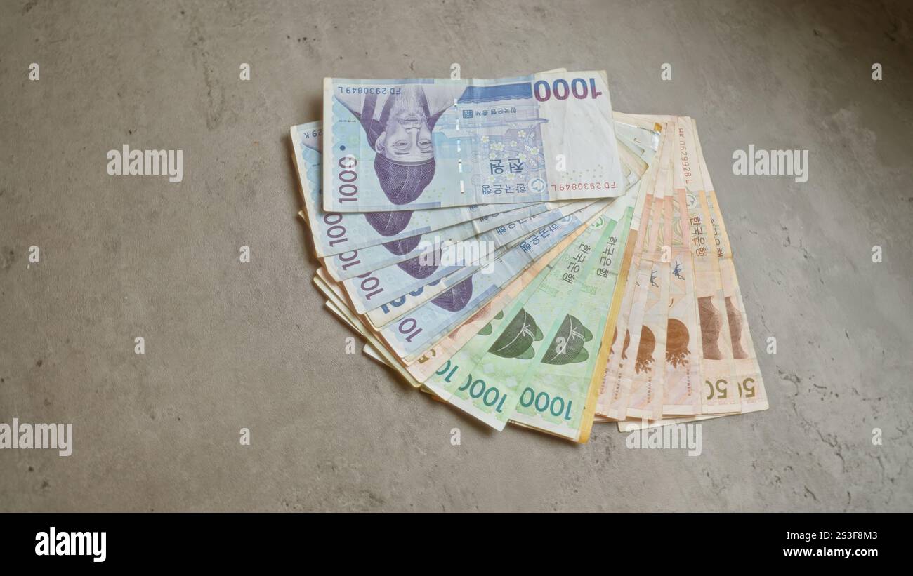 South korean banknotes spread out on a concrete surface showcasing ...