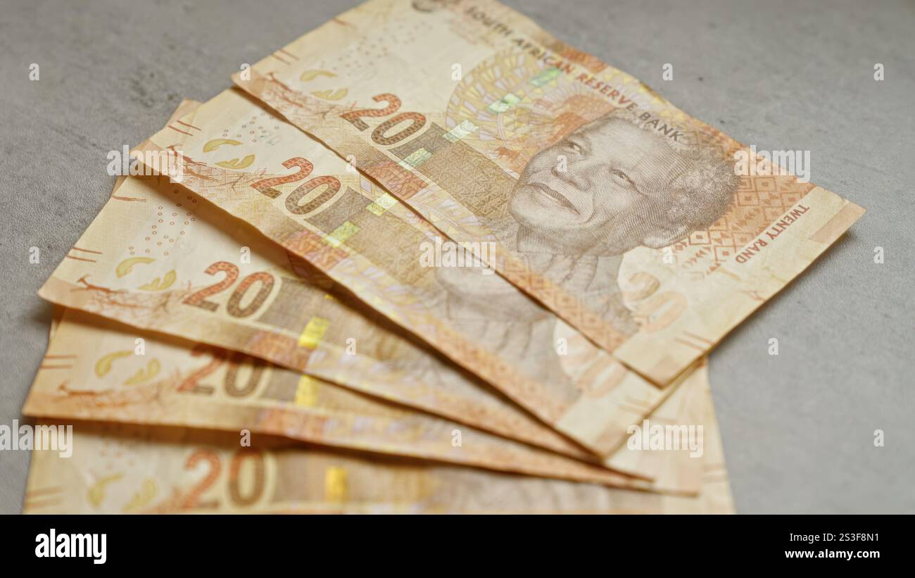 South african banknotes featuring nelson mandela are spread out on a ...