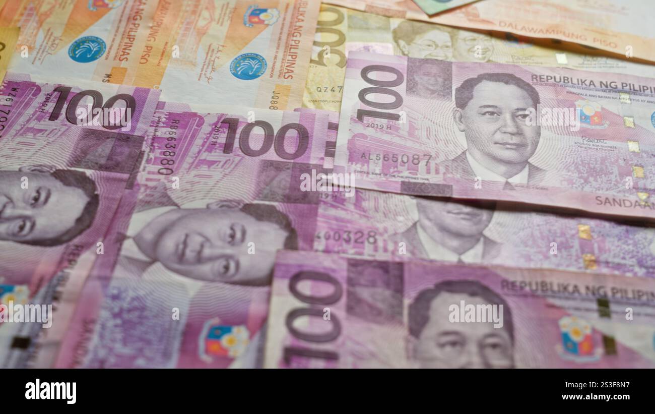 Philippine banknotes scattered, showcasing various denominations of ...