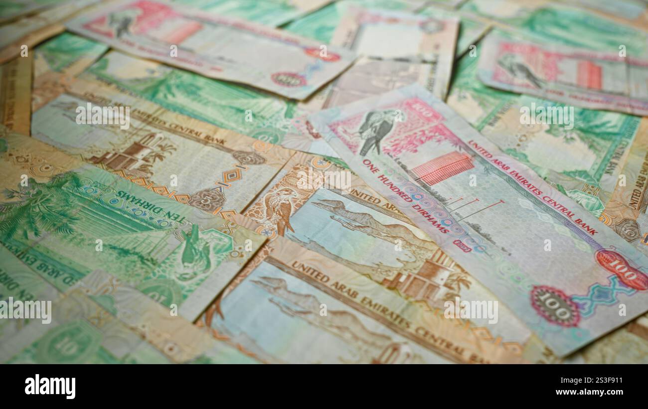 United arab emirates banknotes scattered, showcasing various ...