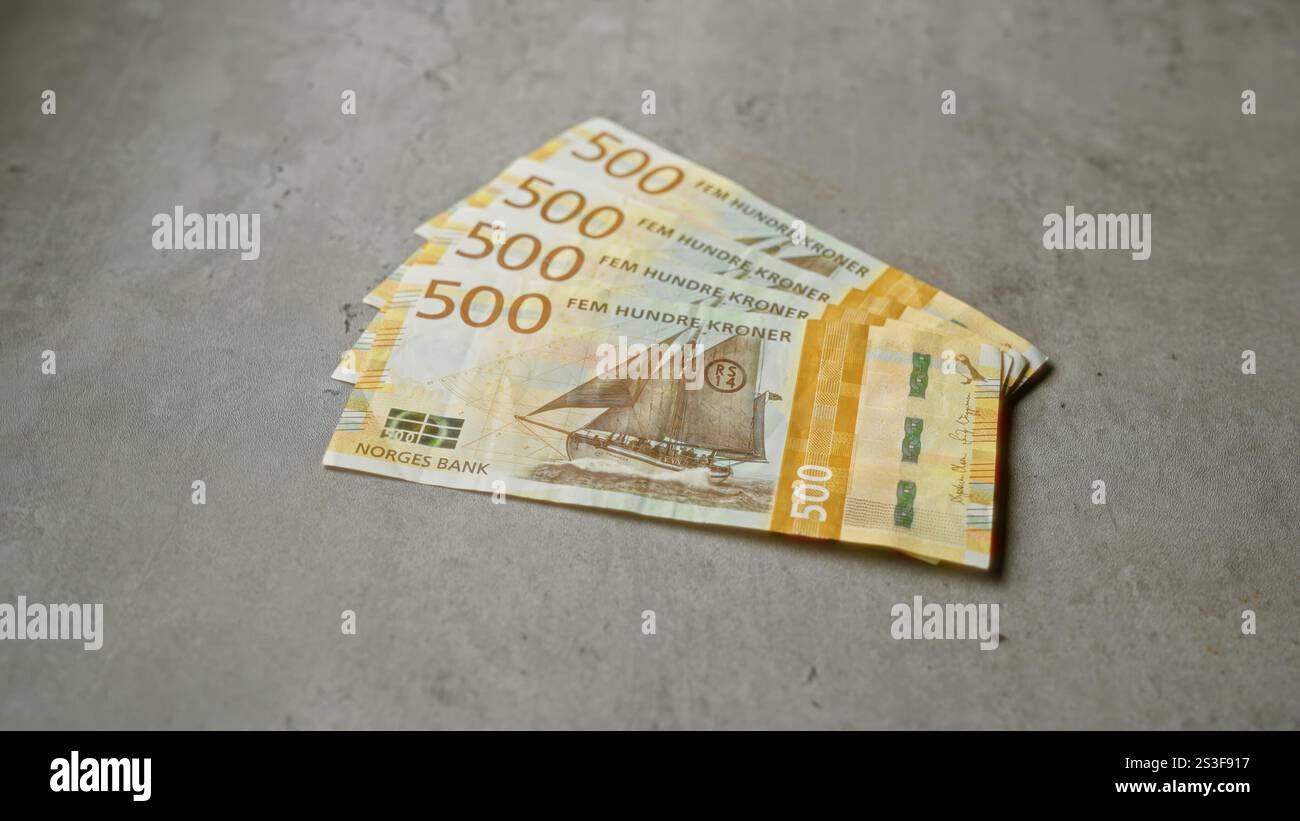 Norwegian 500 kroner banknotes lying on a concrete surface ...