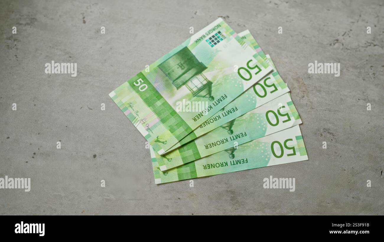 Norwegian 50 kroner banknotes spread on concrete background, showcasing ...