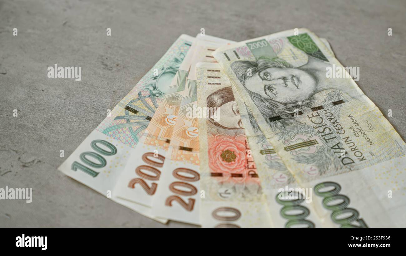 Czech koruna banknotes displayed on a concrete surface highlight the ...